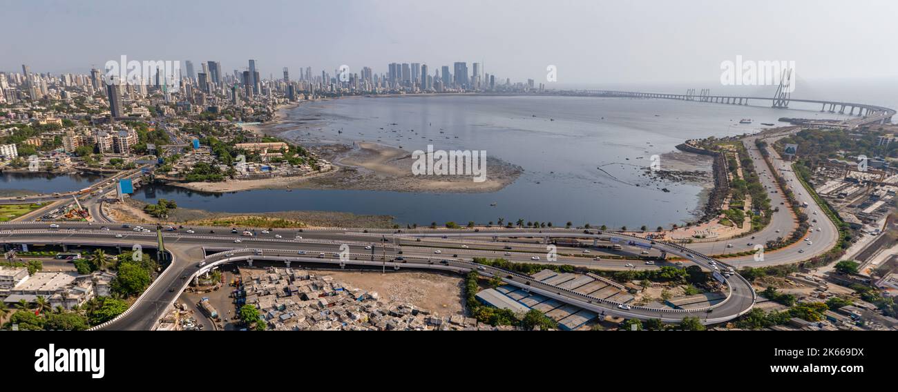 An aerial view of cityscape Mumbai surrounded by buildings and water ...