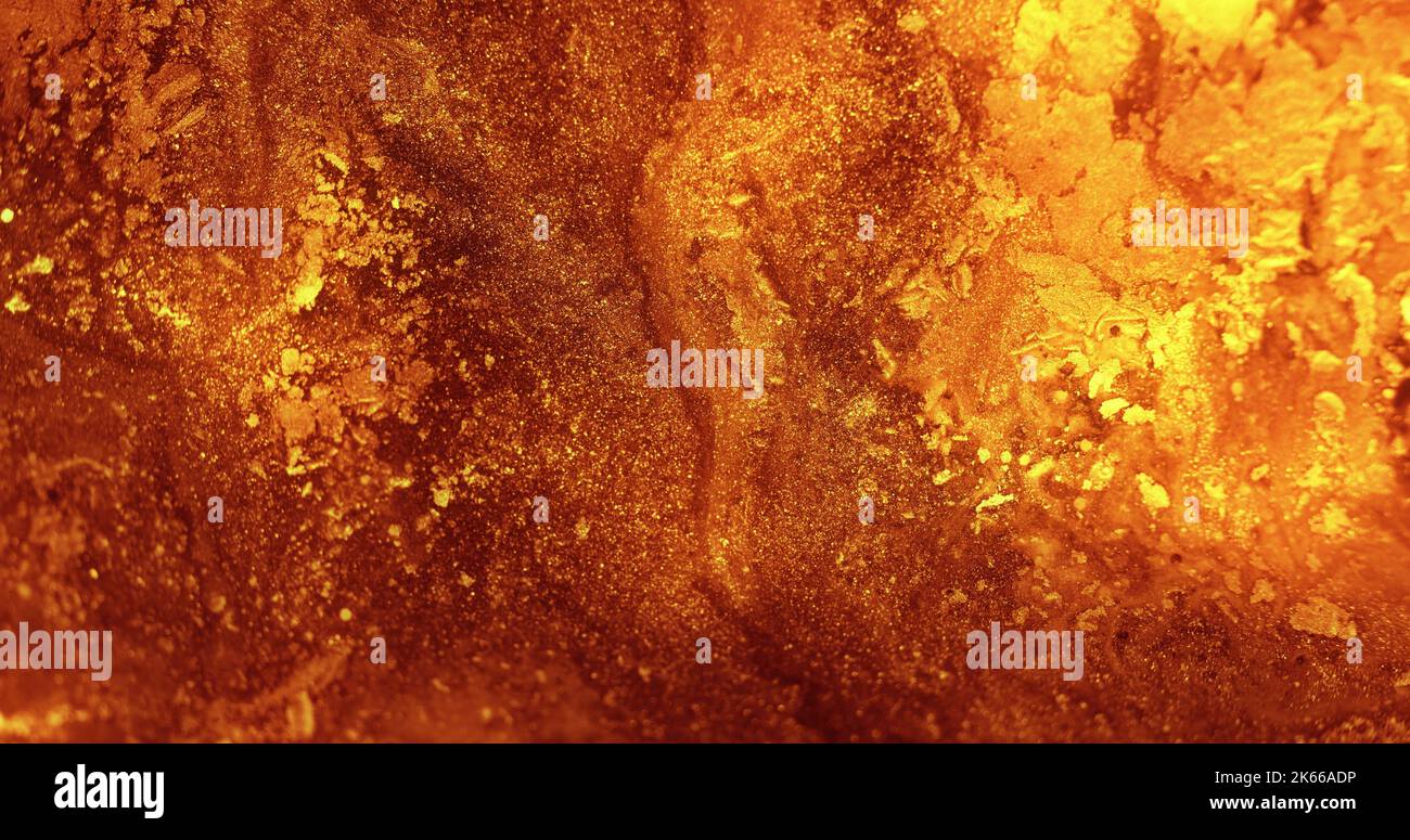 glitter ink background paint mix golden glow fluid Stock Photo - Alamy