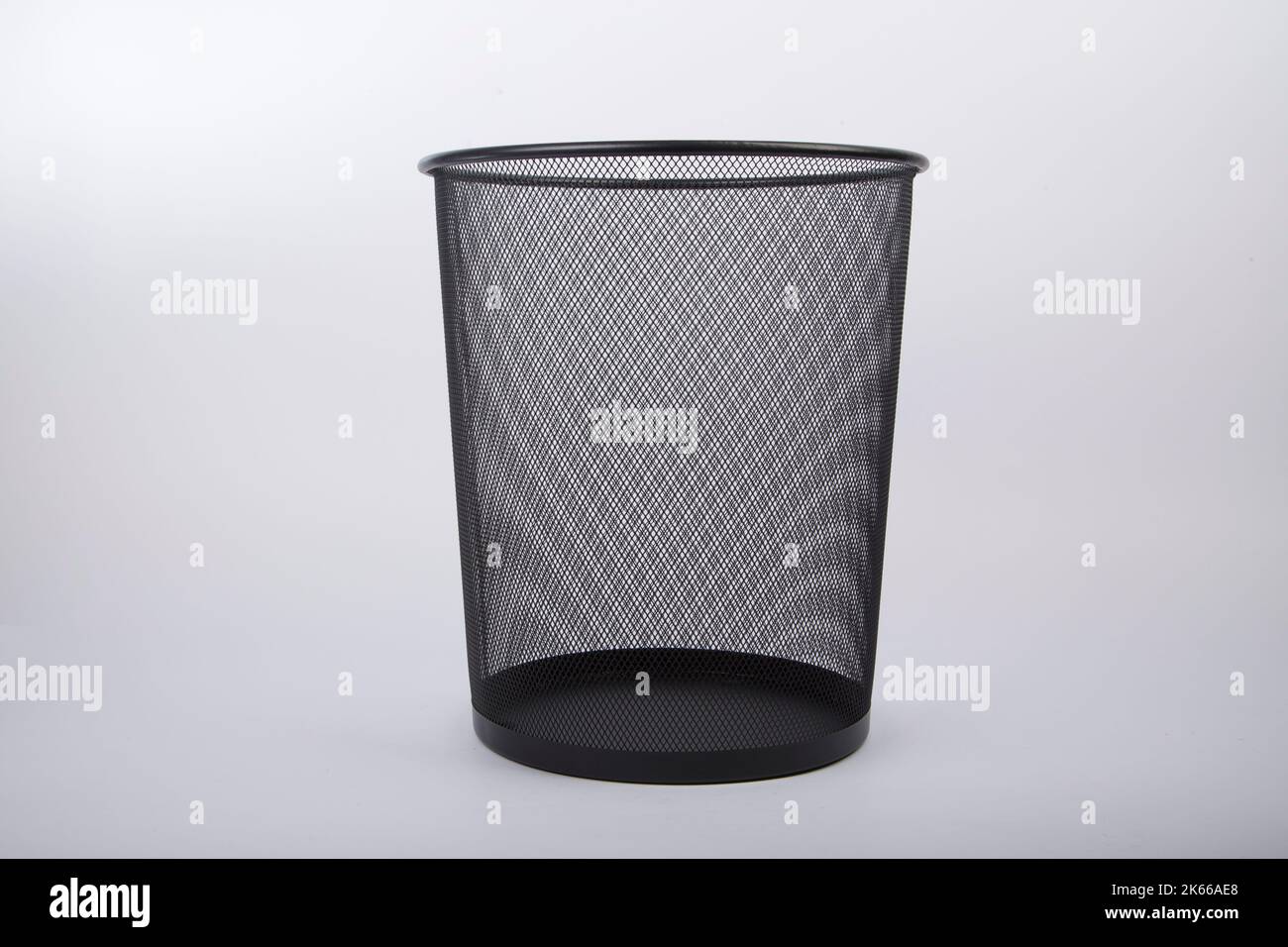 A metallic garbage can isolated on a gray background Stock Photo - Alamy