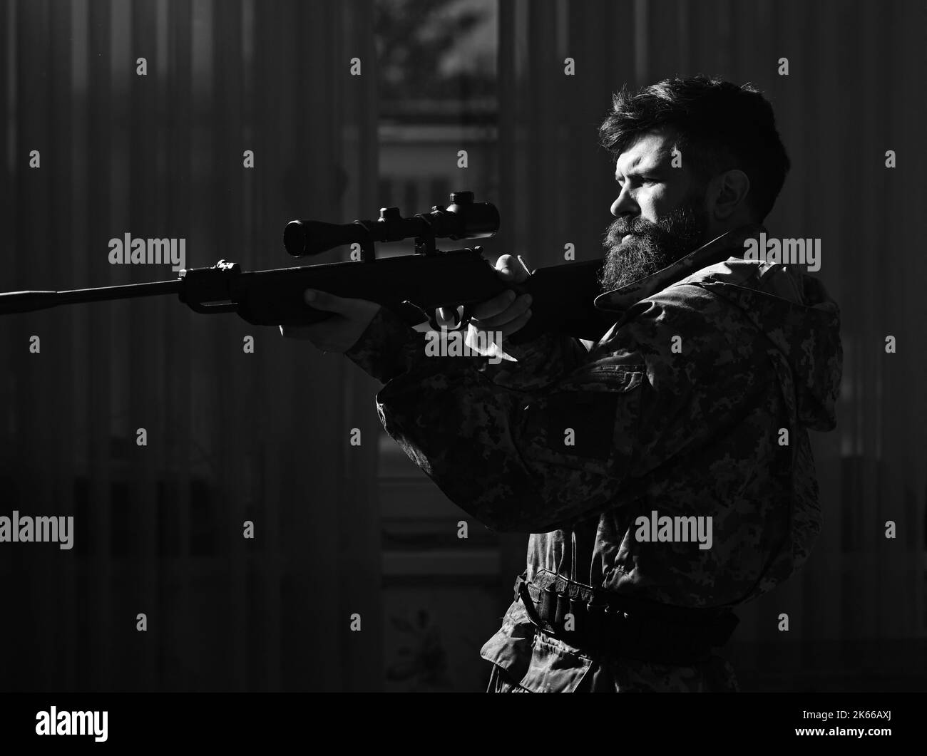 Macho on suffering grimace face aiming at victim. Hunter, soldier with ...