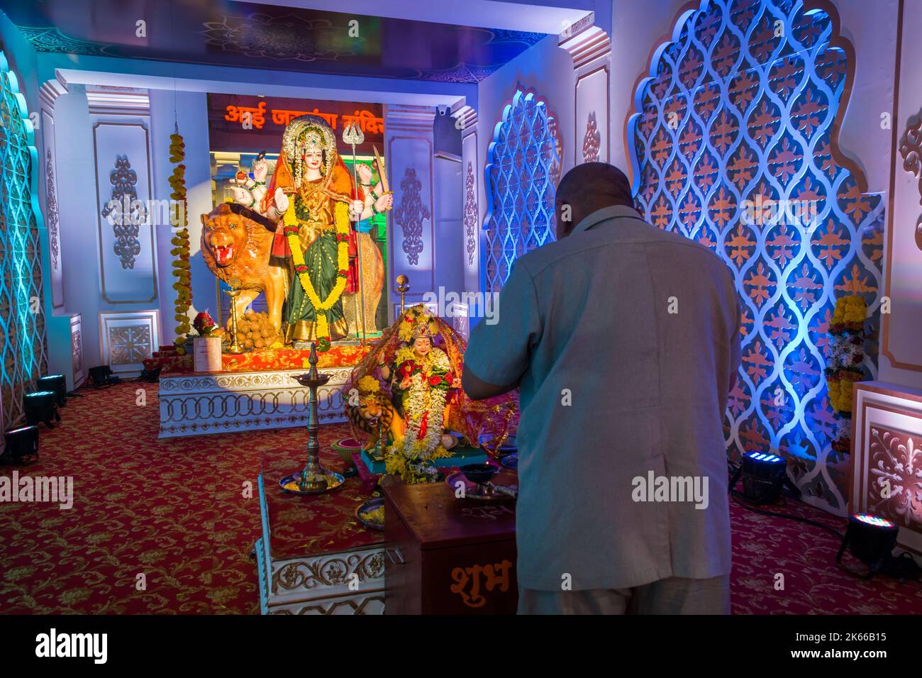 A man praying before an idol of Maa Durga at a mandal in Mumbai for the ...