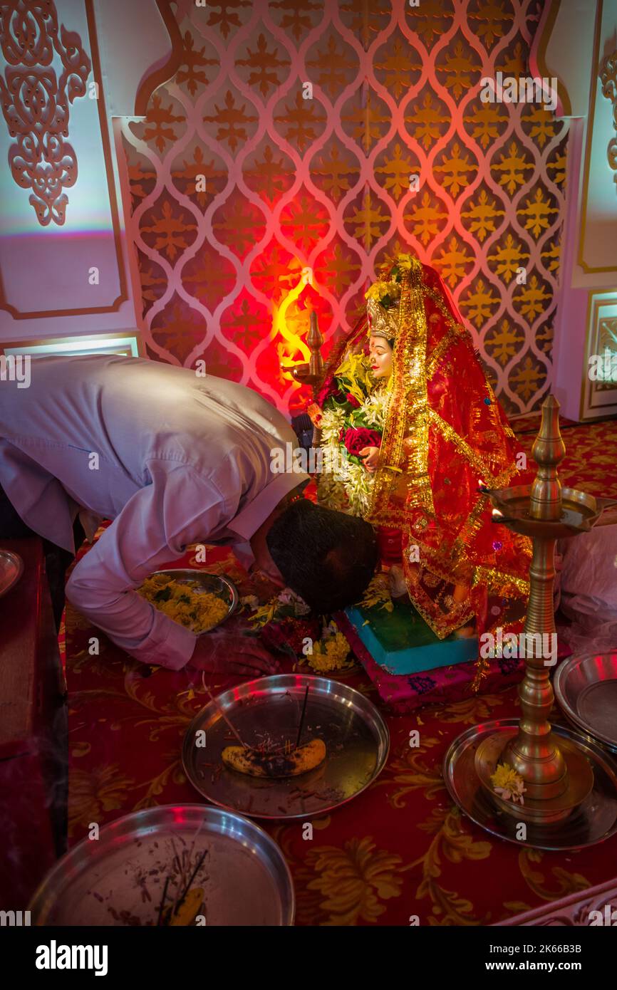 A man praying before an idol of Maa Durga at a mandal in Mumbai for the ...