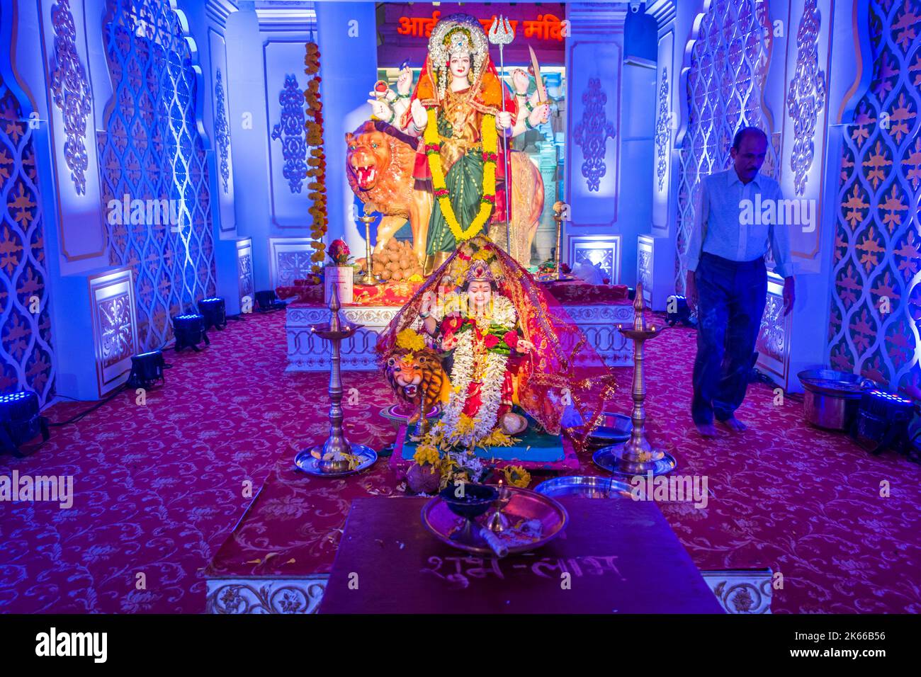 A man walking near an idol of Maa Durga at a mandal in Mumbai for the ...