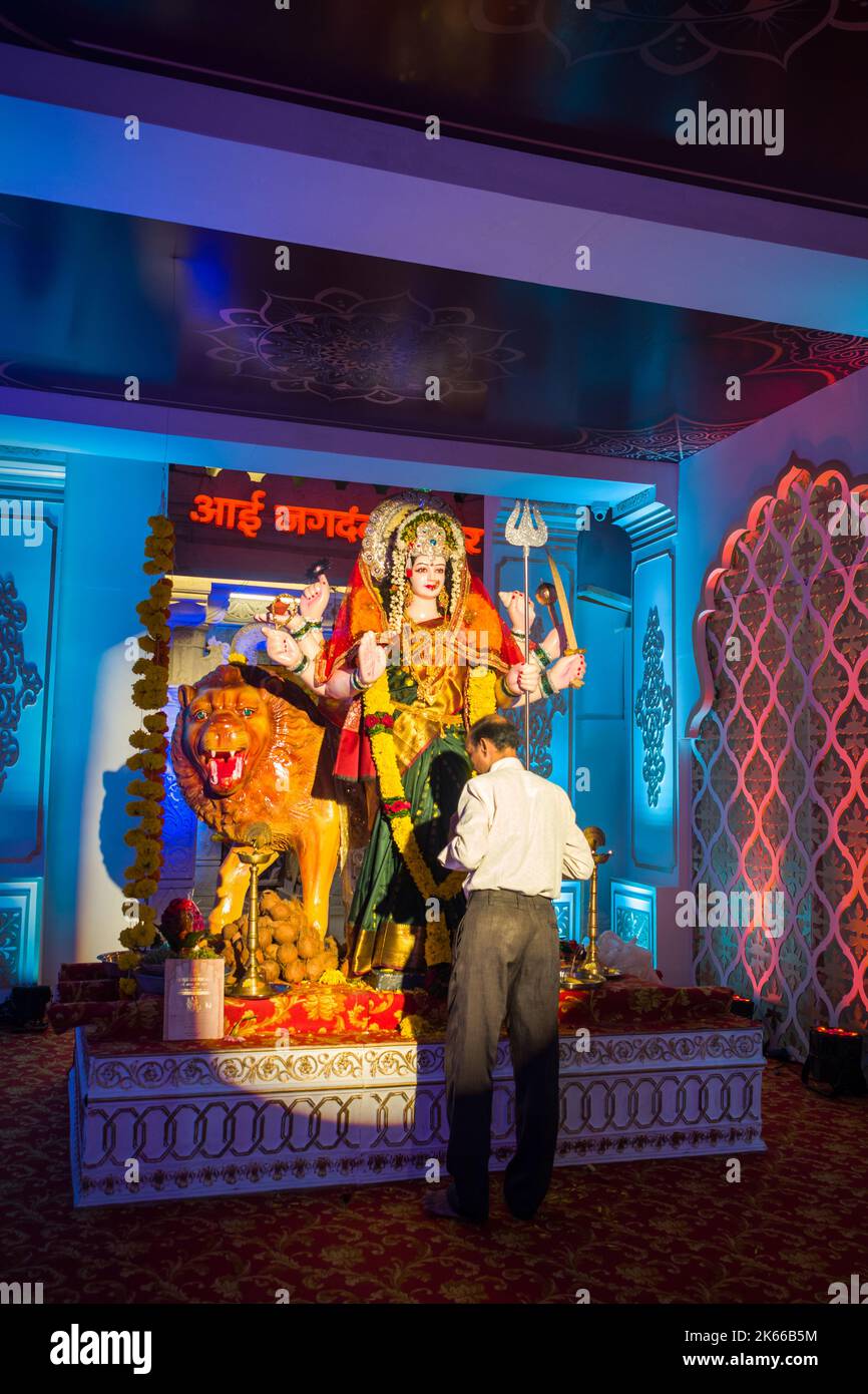A man praying before an idol of Maa Durga at a mandal in Mumbai for the ...