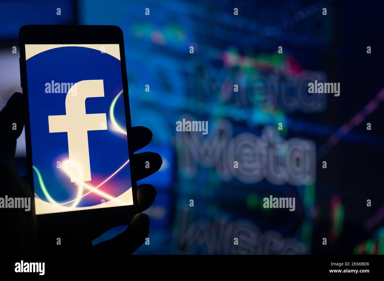 A smartphone with Facebook logo on the screen against the blurry ...