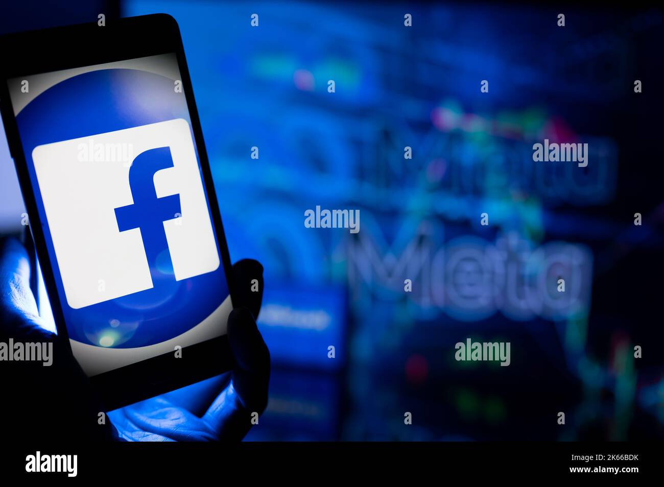 A smartphone with Facebook logo on the screen against the blurry ...