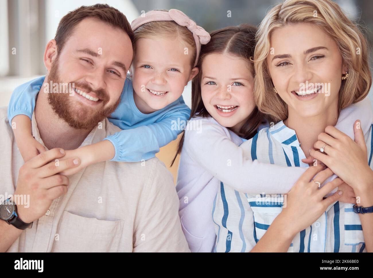 Portrait of happy young caucasian family sitting together at home ...