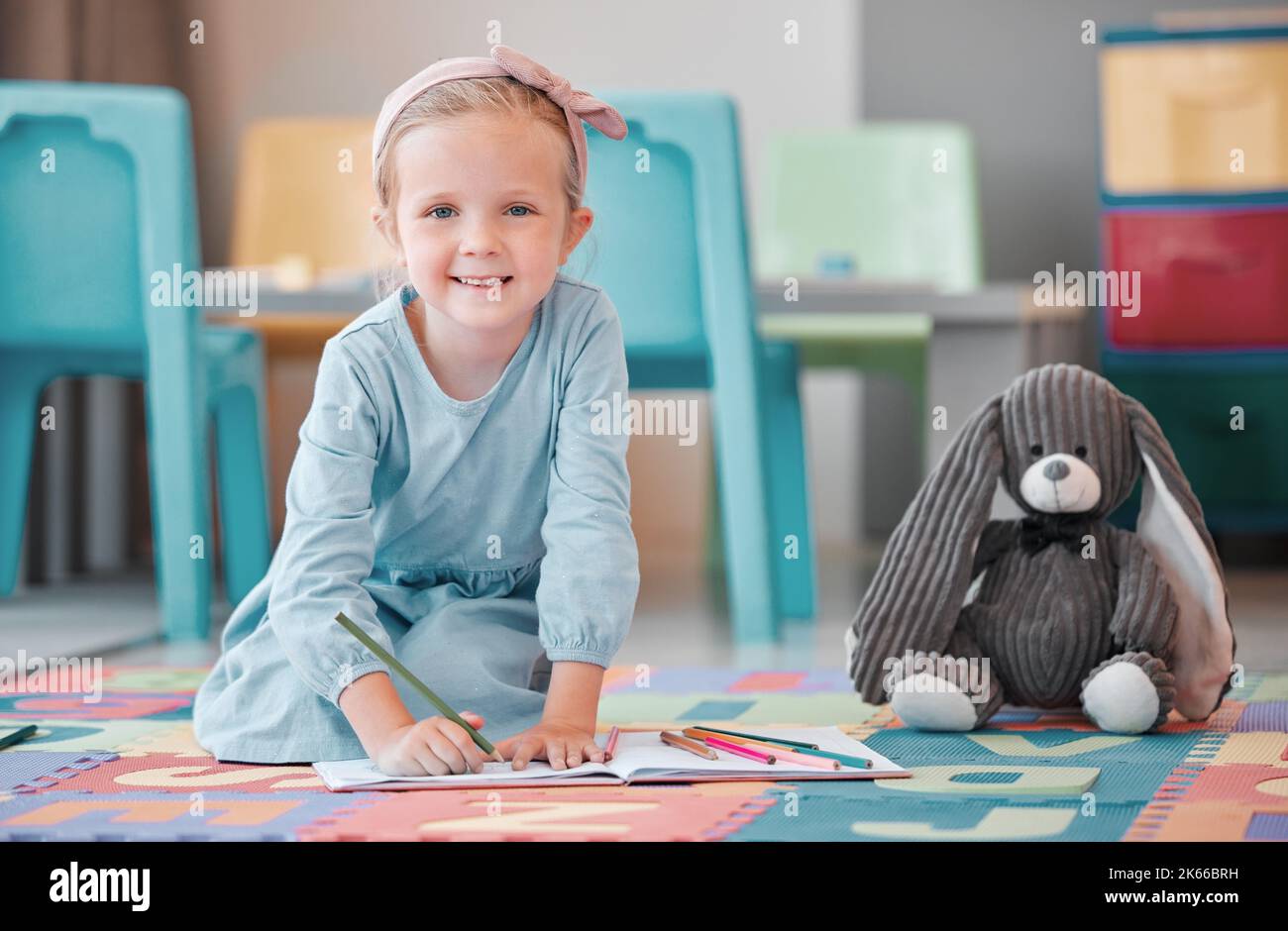 Portrait of one adorable little caucasian girl with a stuffed rabbit ...