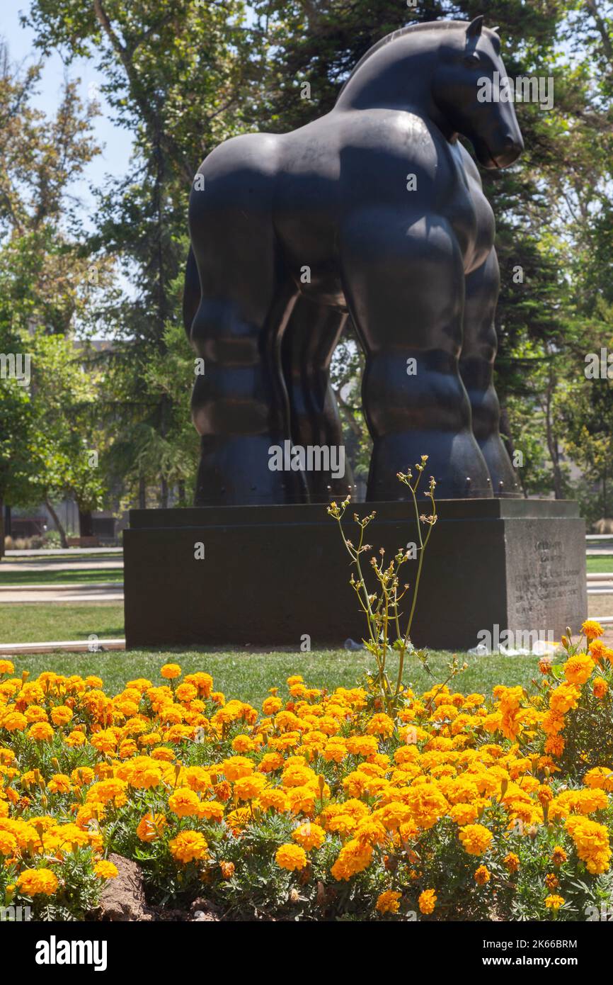 A vertical shot of as sculpture of a fat horse from Fernando Botero in ...