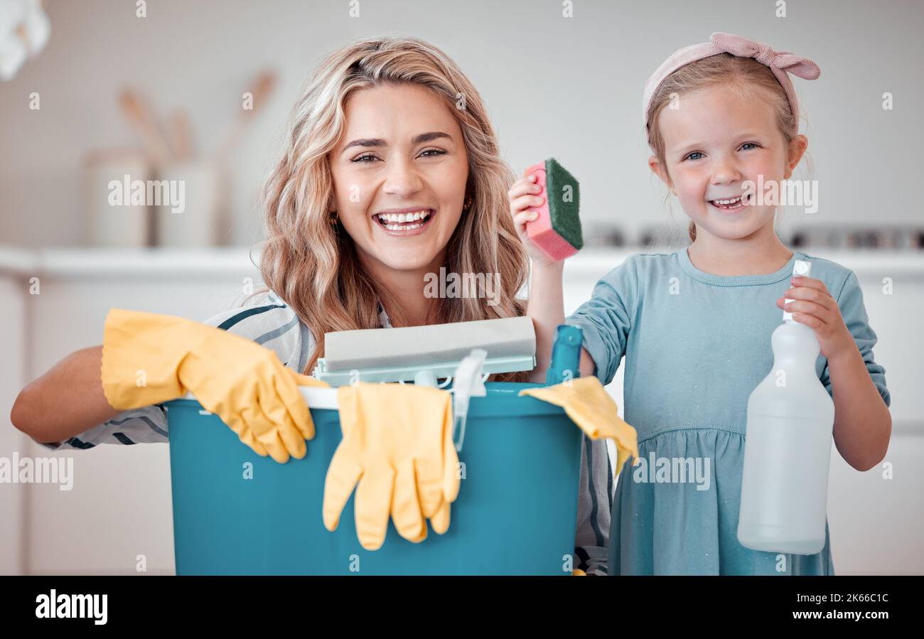 Cute cheerful little girl helping her mother clean at home. Happy ...