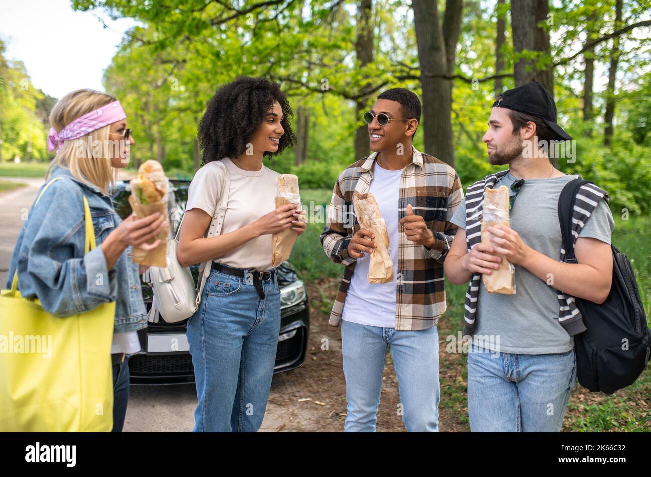 Group young friends eating sandwiches hi-res stock photography and ...