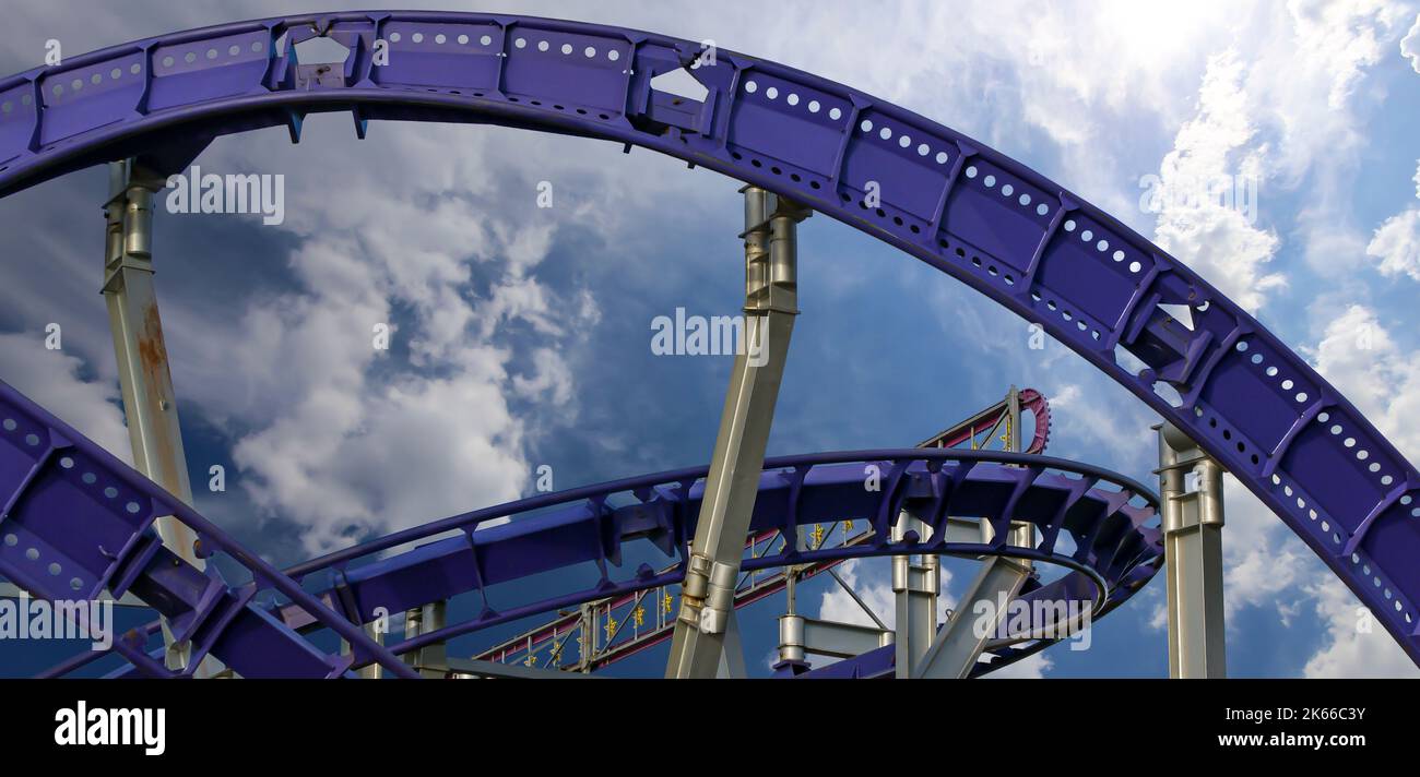 Attraction roller-coaster (switchback) on the background of the cloudy ...