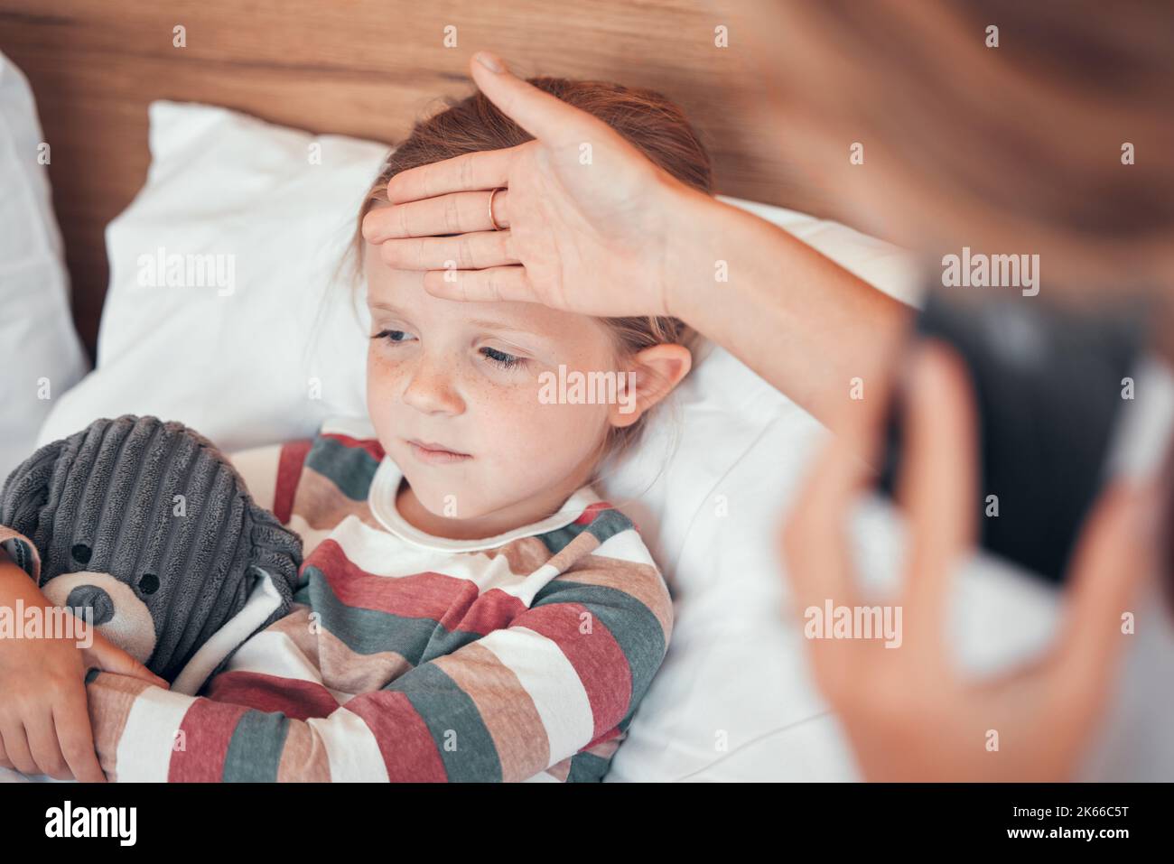 Closeup shot of a cute little caucasian girl looking sick and unwell ...