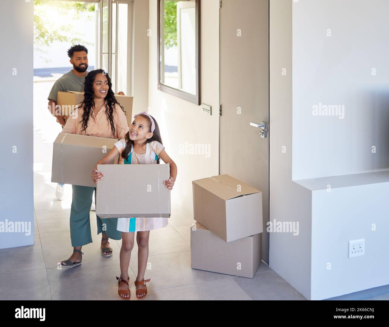 Ready for something new. a young family moving into their new house ...