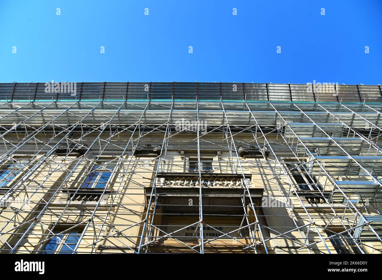 A low angle view ofa scaffolding surrounding an ancient building for ...