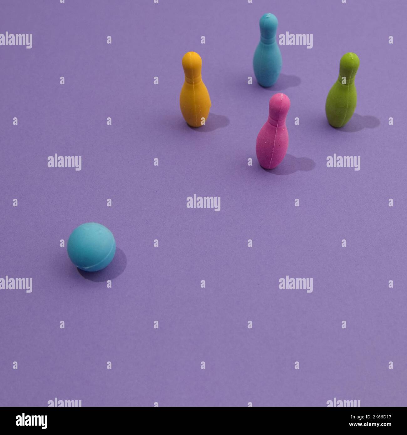 A beautiful shot of colorful bowling pins with a blue ball on the ...