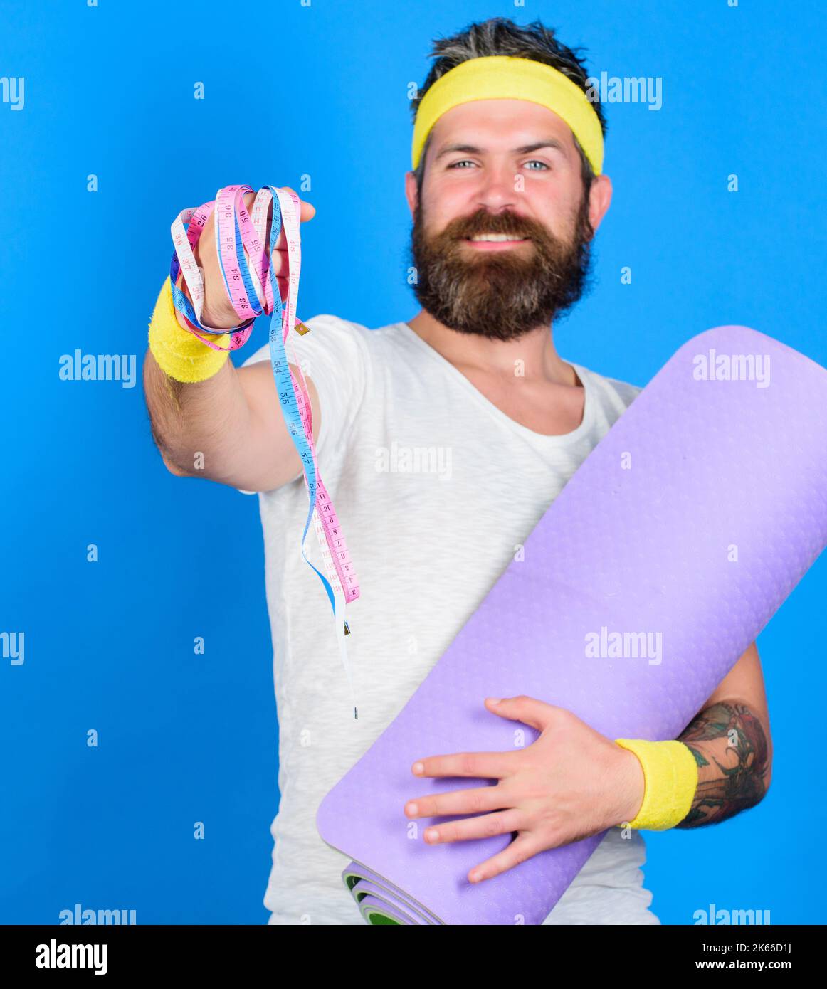 Athlete wear bandages for sweat. Man bearded athlete hold fitness mat ...