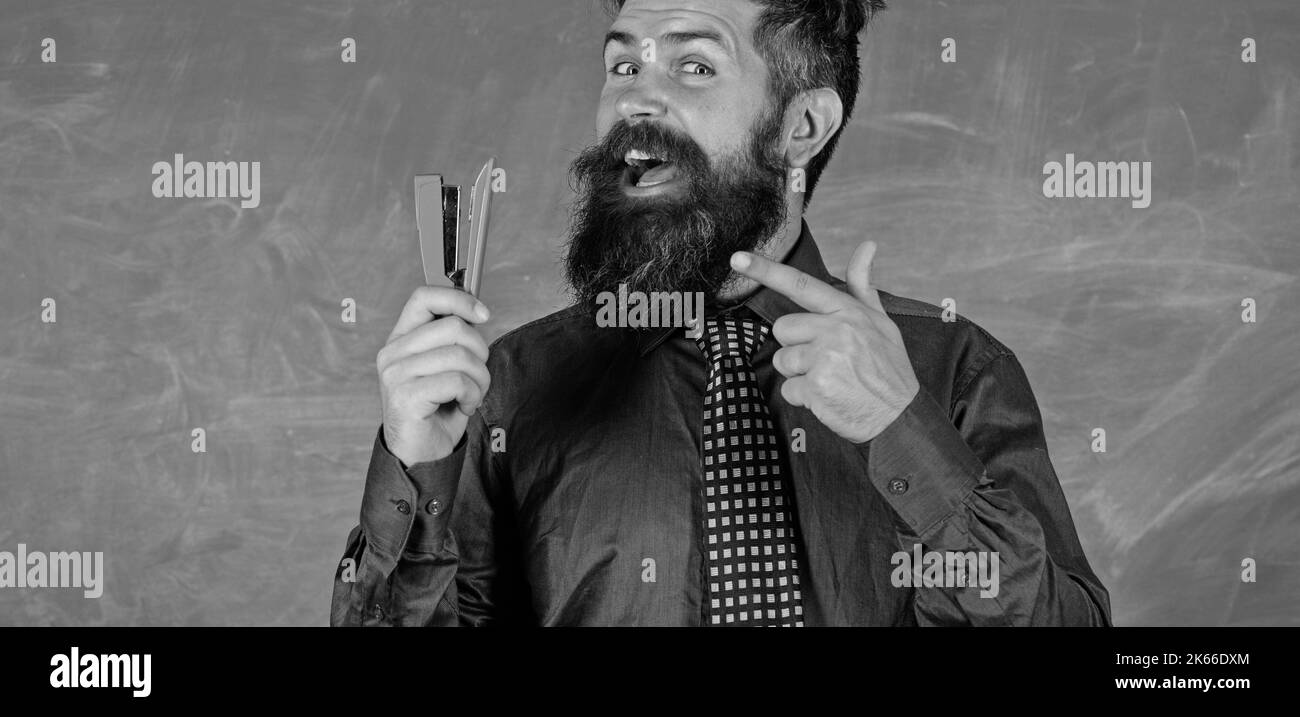 Teacher bearded man with stapler chalkboard background. Prepare for ...