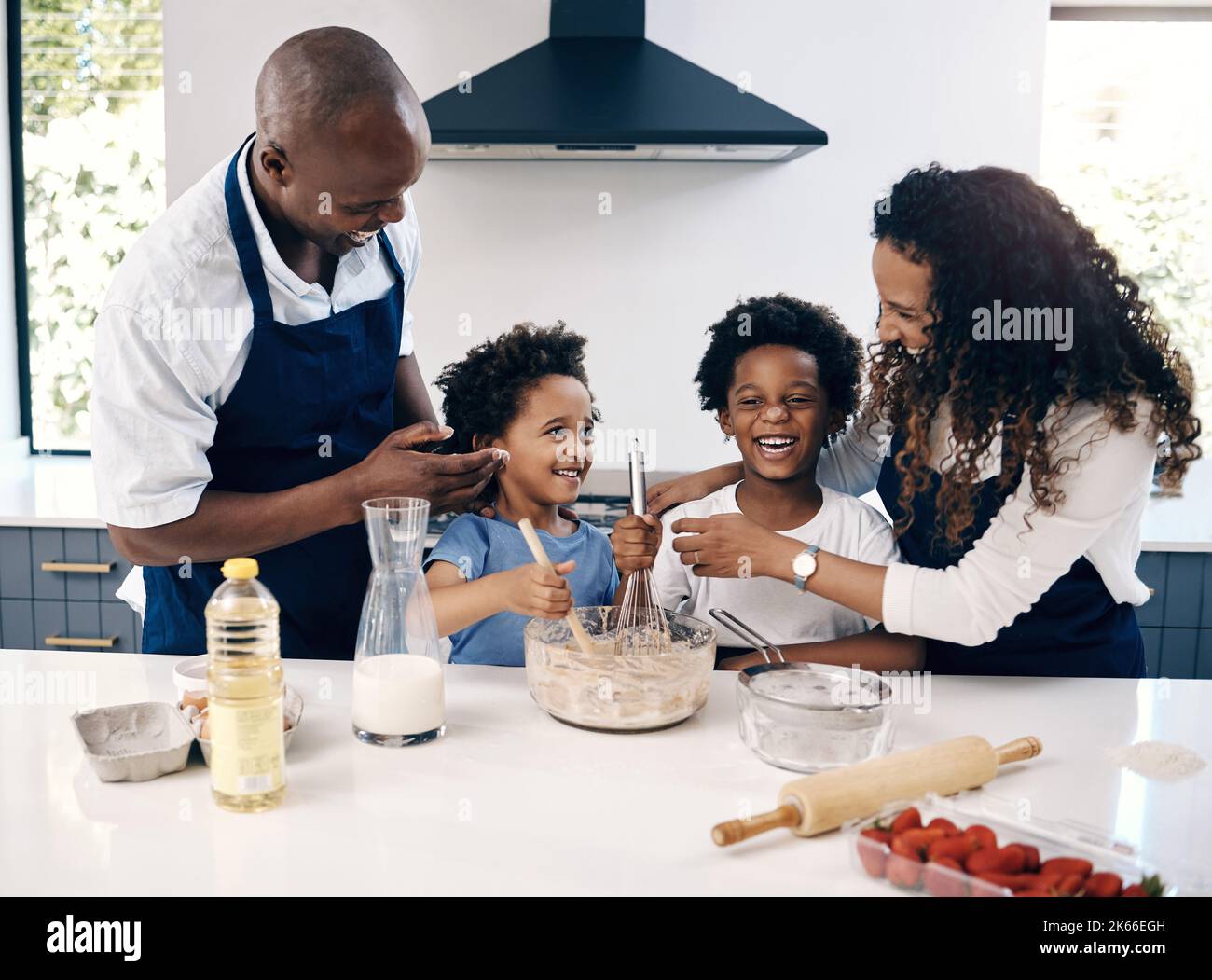 Happy african american family baking in their kitchen together ...