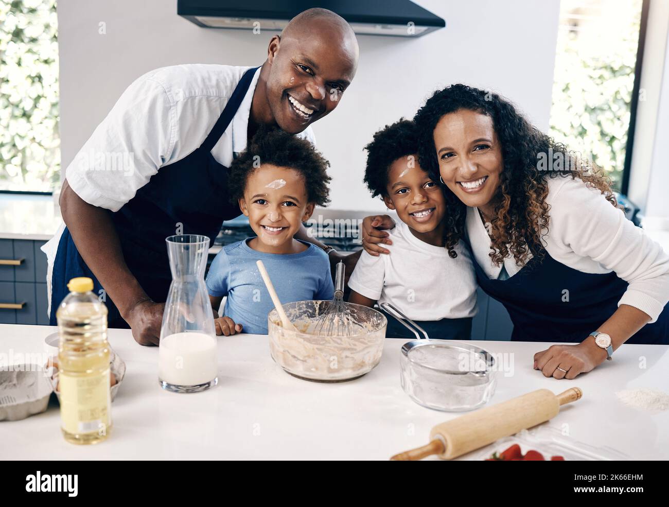 Portrait of cheerful african american family baking together at home ...