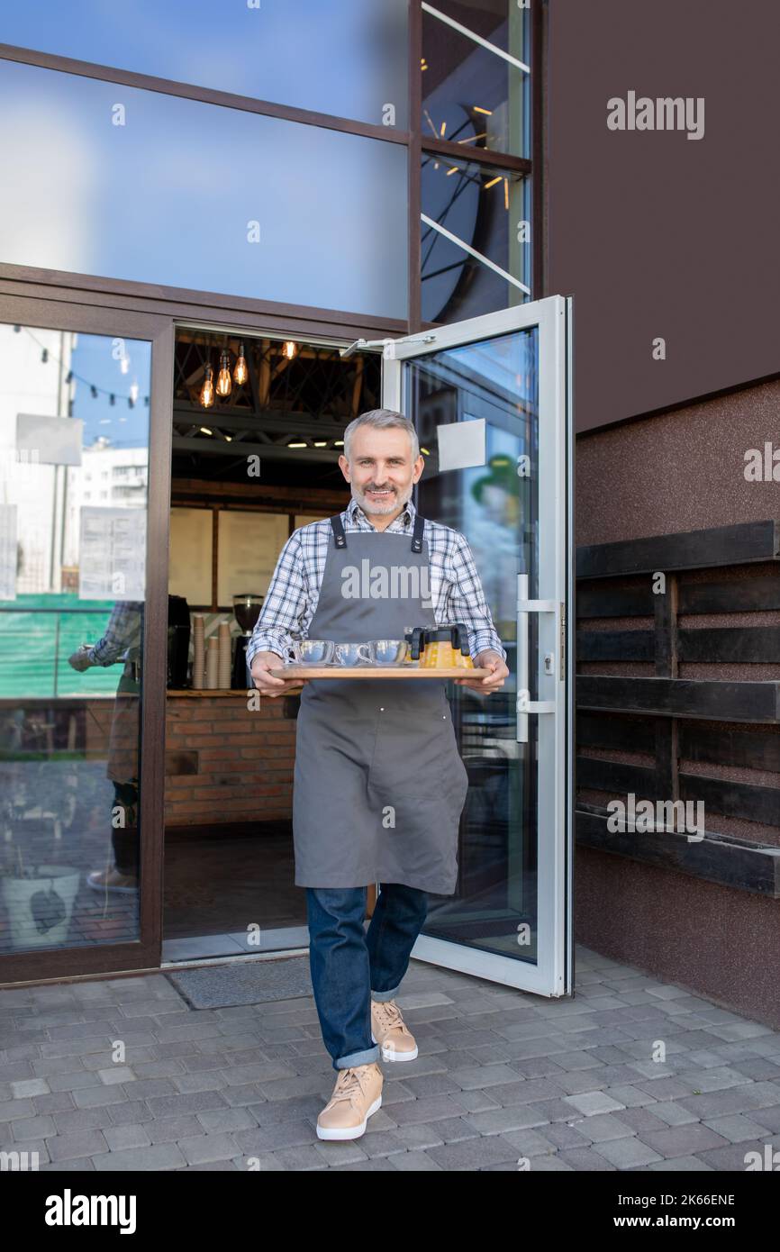 Male carrying tray hi-res stock photography and images - Alamy