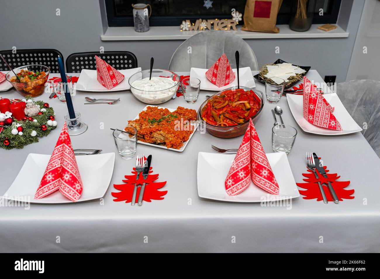 A table set before dinner for Christmas in Poland, visible baked fish ...
