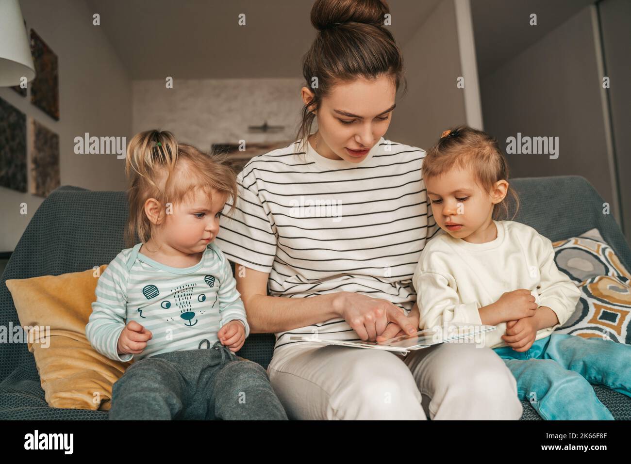 Family of three involved in reading a fairy tale Stock Photo - Alamy