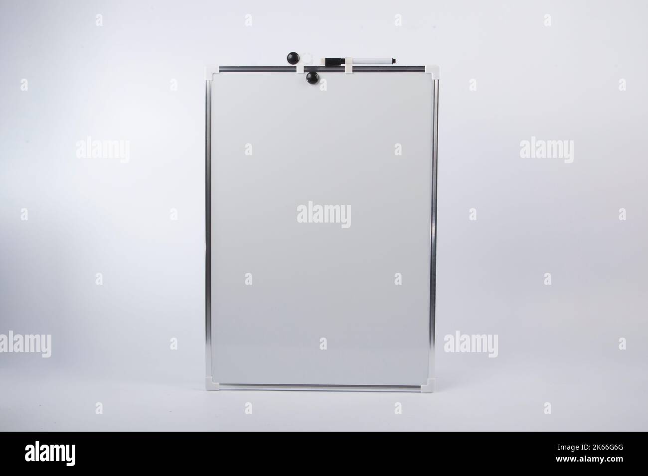 A rectangle whiteboard with a marker isolated on a gray background ...