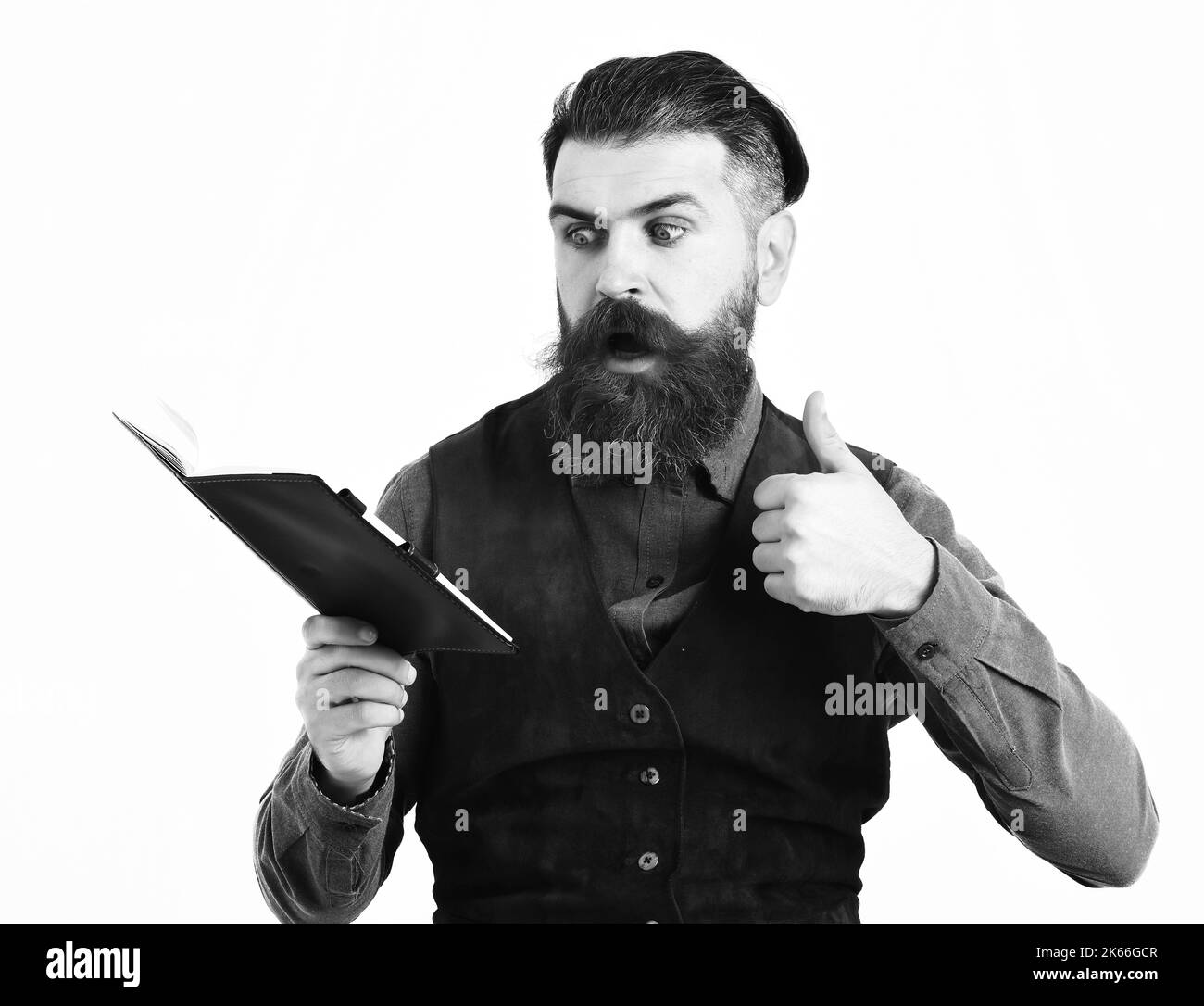 bearded man holding notepad with surprised face Stock Photo - Alamy