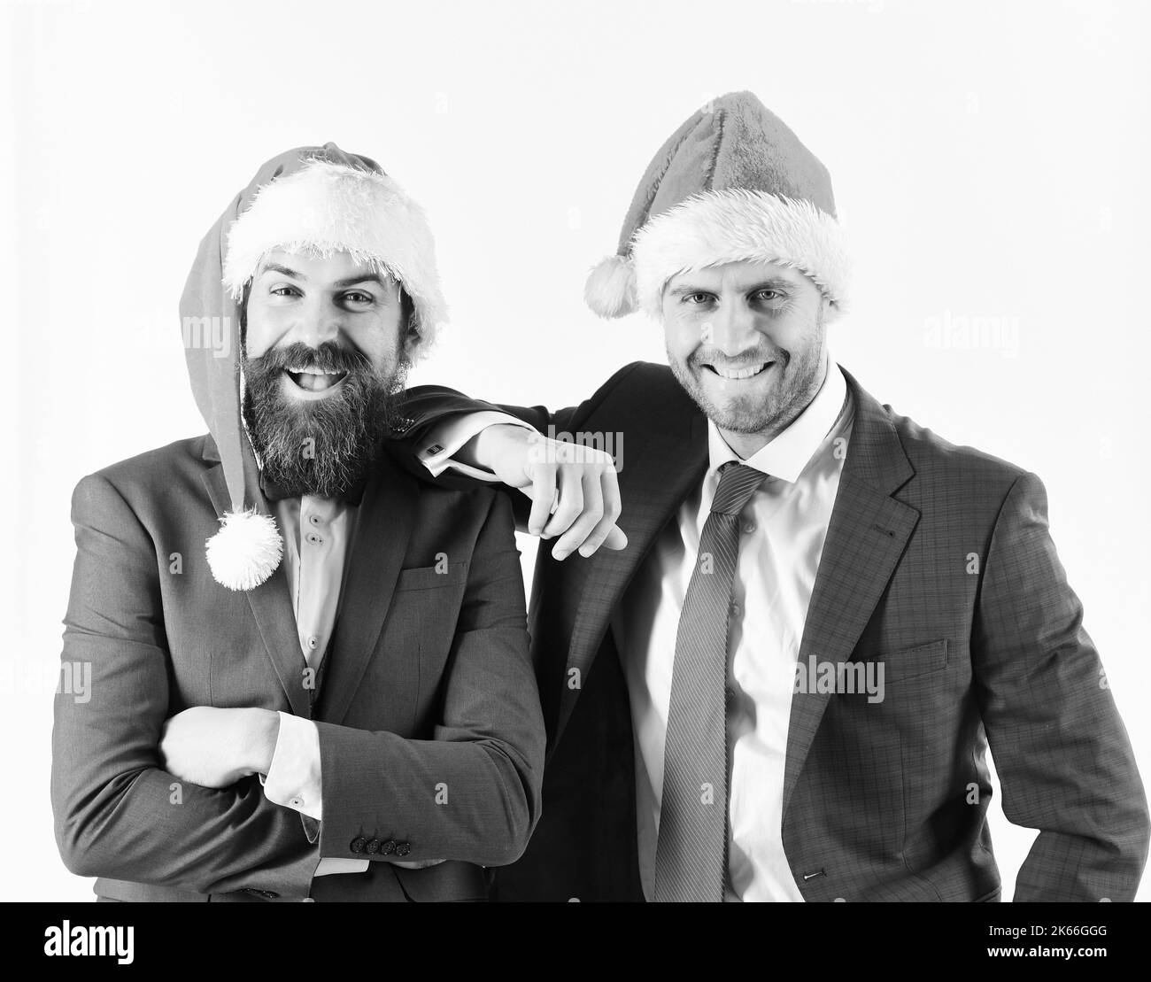 Men in smart suits and Santa hats on white background Stock Photo - Alamy