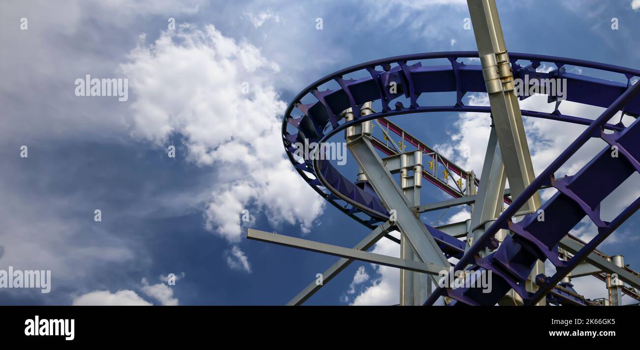 Attraction roller-coaster (switchback) on the background of the cloudy ...