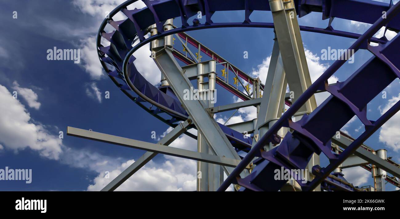 Attraction roller-coaster (switchback) on the background of the cloudy ...