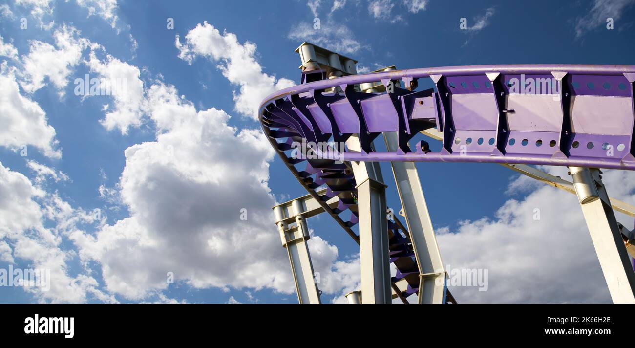 Attraction roller-coaster (switchback) on the background of the cloudy ...