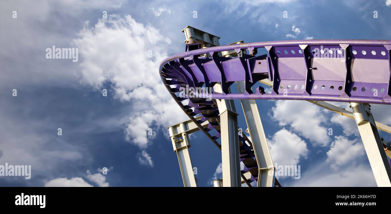 Attraction roller-coaster (switchback) on the background of the cloudy ...