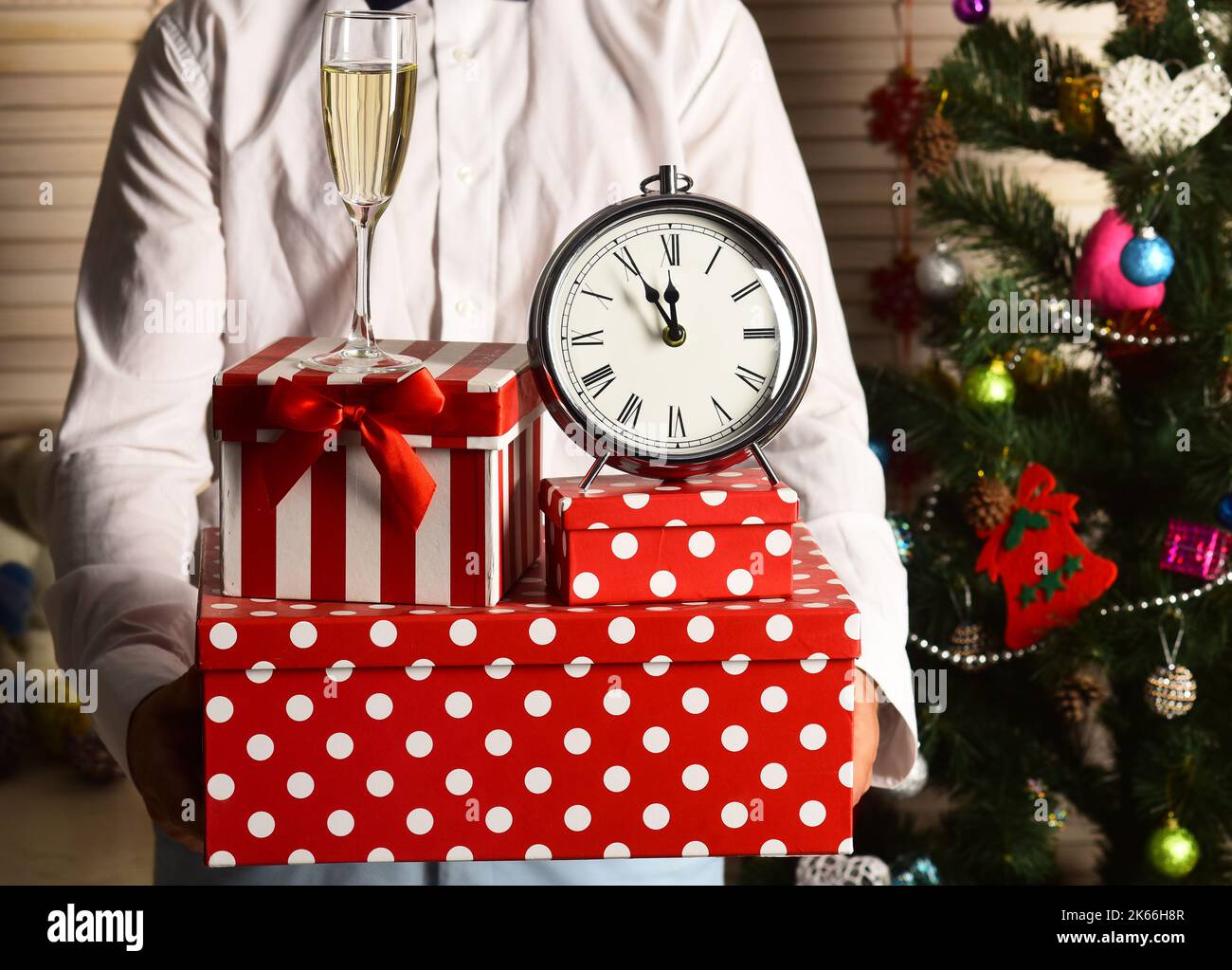 Male hands hold present boxes, champagne glass and alarm clock Stock ...