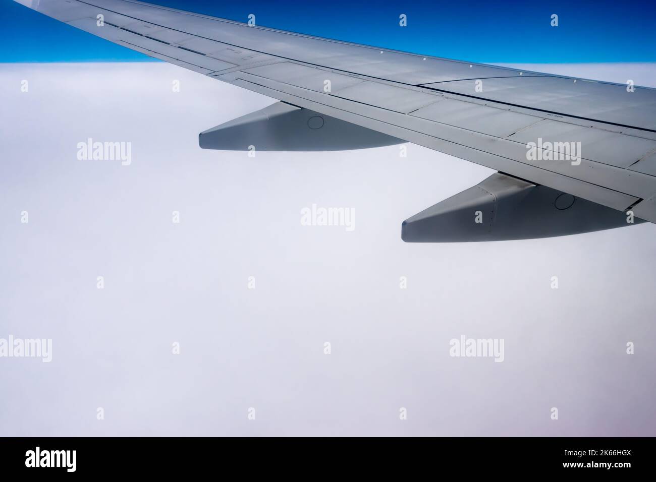 View from the plane window to the wing. Photo taken while flying above ...