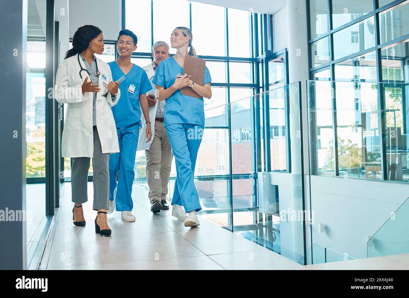 On their way to save lives. a group of doctors having a discussion at a ...
