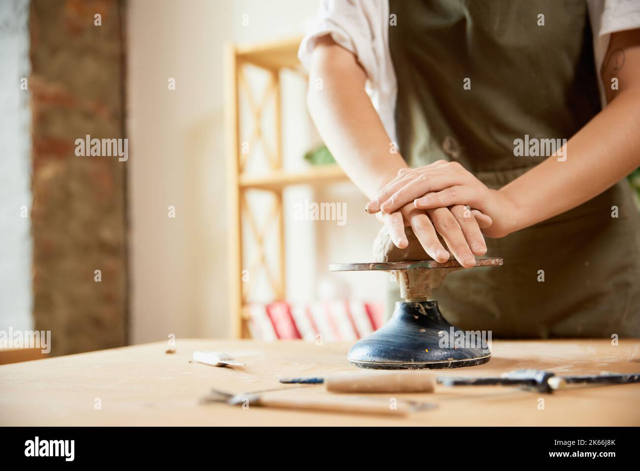 Young female pottery master with supplies recording vlog at home studio ...