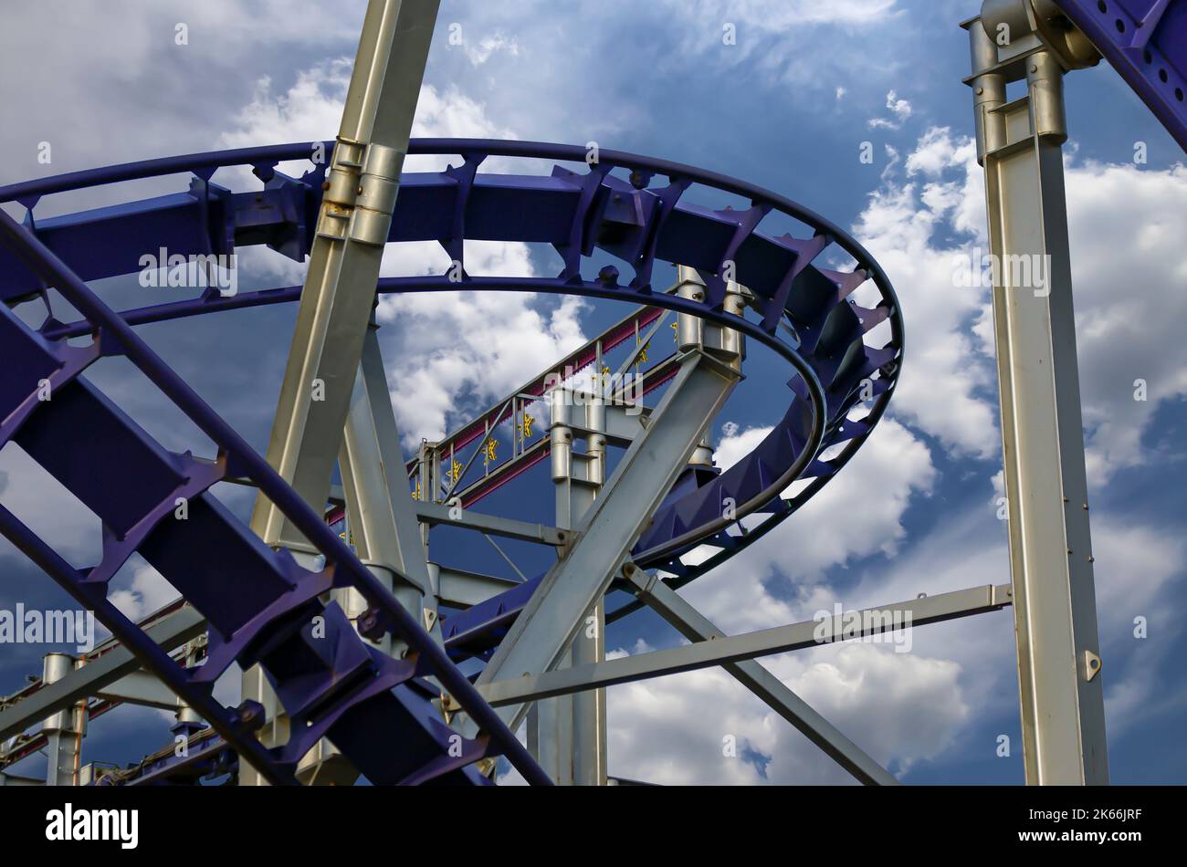 Attraction roller-coaster (switchback) on the background of the cloudy ...