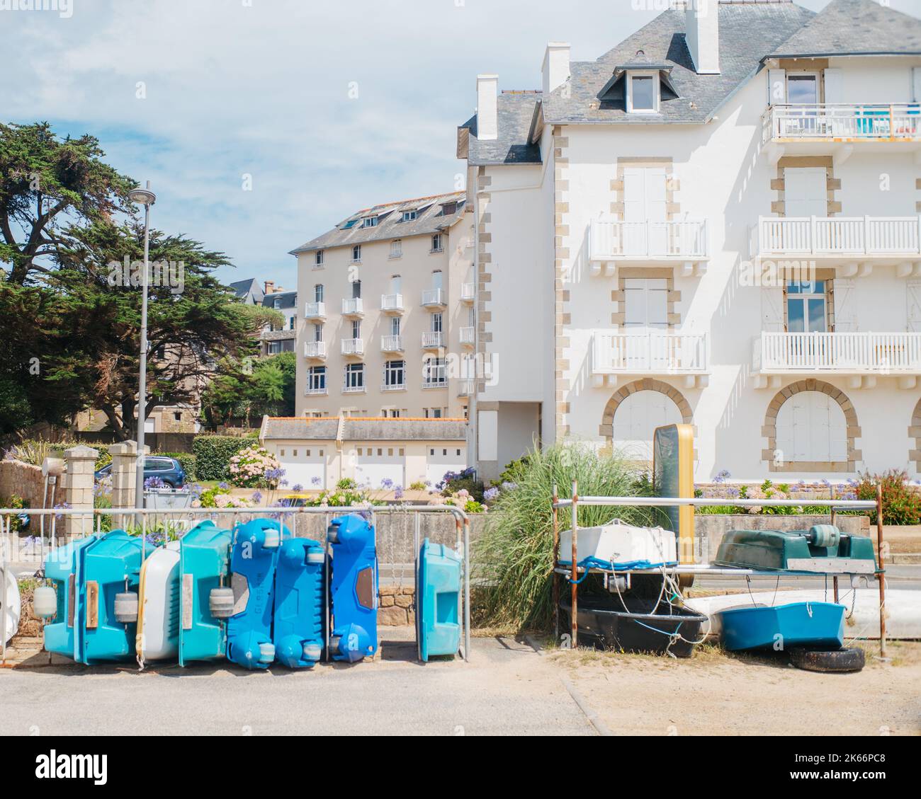 A costal buildings with blue small boats in front on a sunny day Stock ...