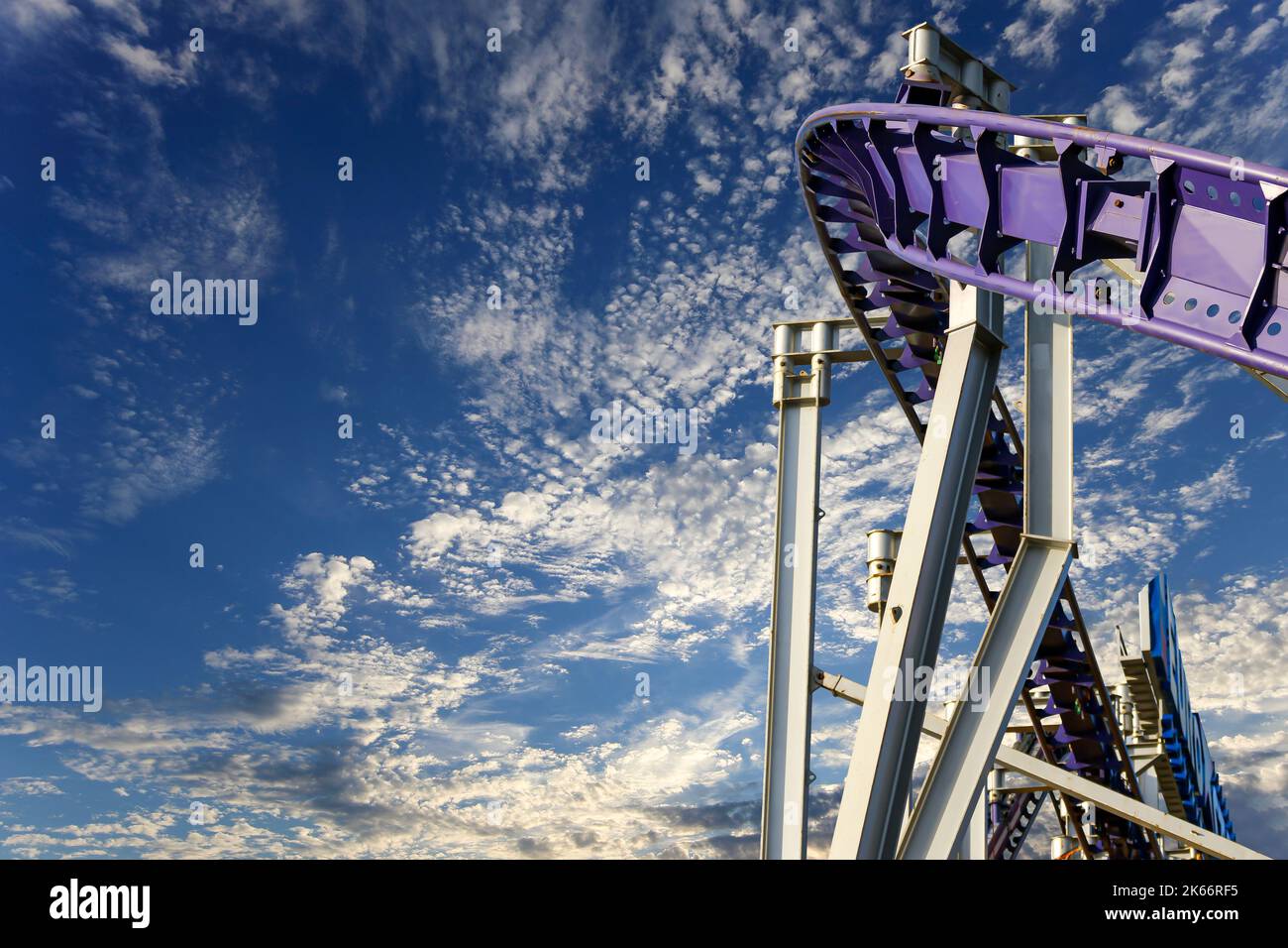 Attraction roller-coaster (switchback) on the background of the cloudy ...