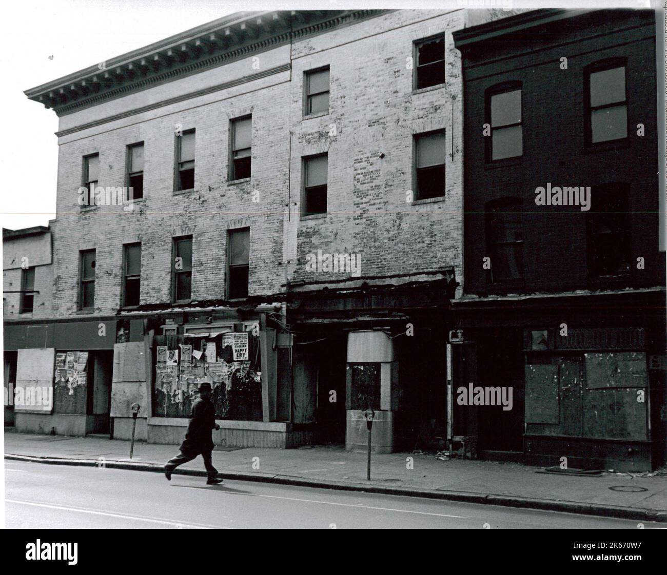 Photograph of Baltimore Man Running to Abandoned Building (Marks left ...