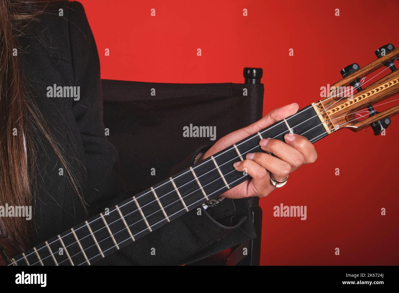 Closeup Young woman playing a CUATRO, typical Venezuelan instrument ...