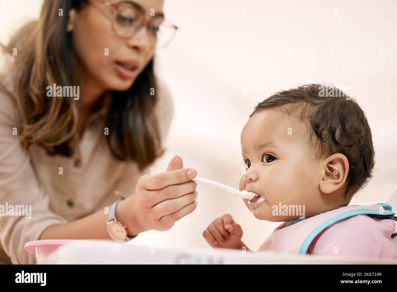 Growing babies need all the nutrition. a woman feeding her baby at home ...