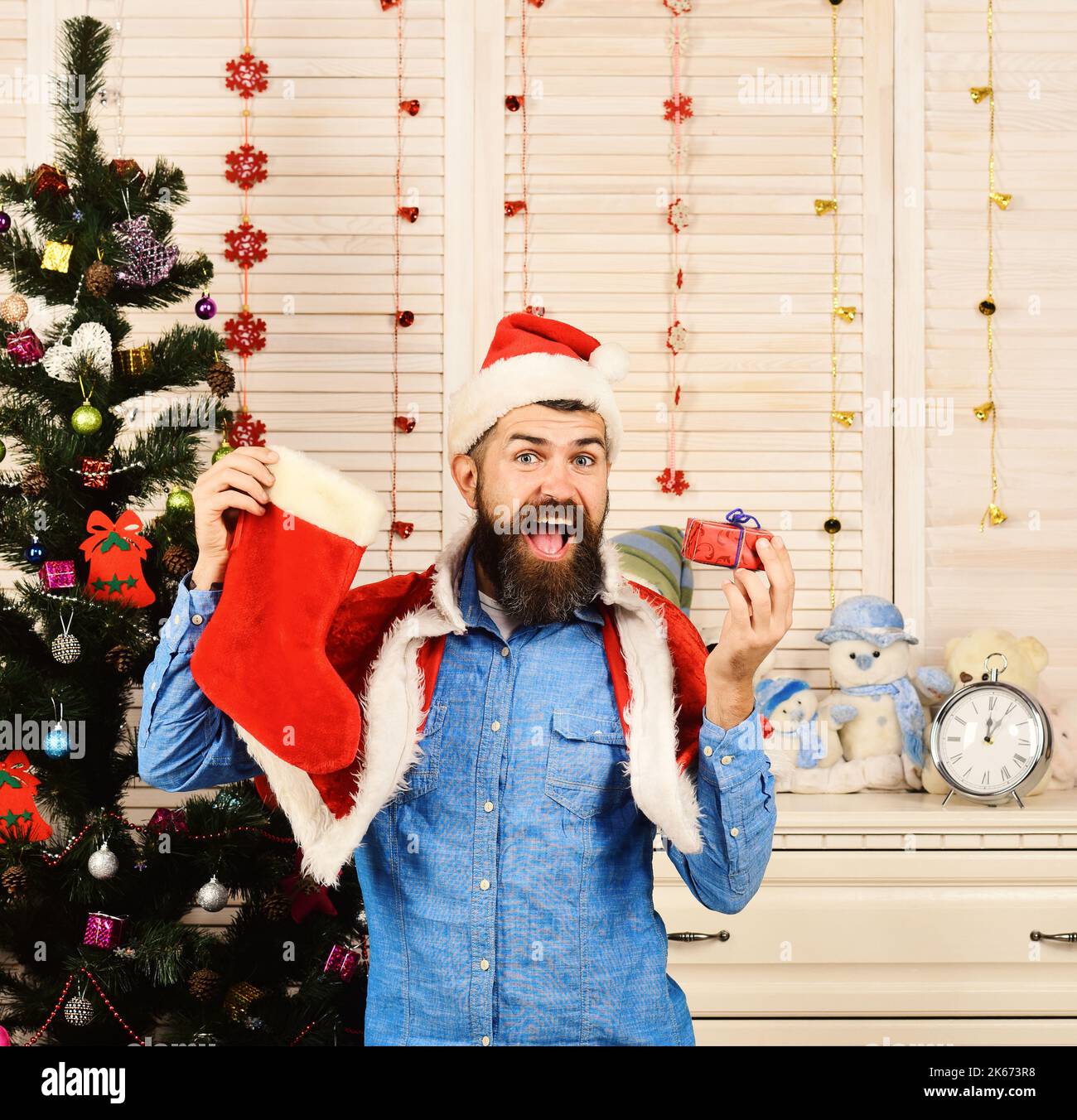 Santa Claus with cheerful face near Christmas tree Stock Photo - Alamy