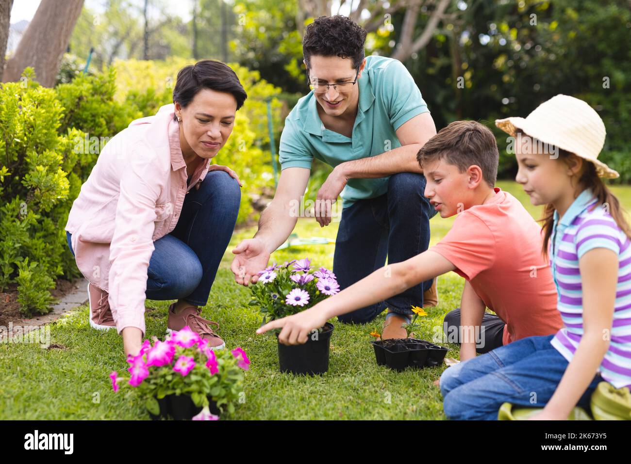 Caucasian family spending time together in the garden, planting Stock ...