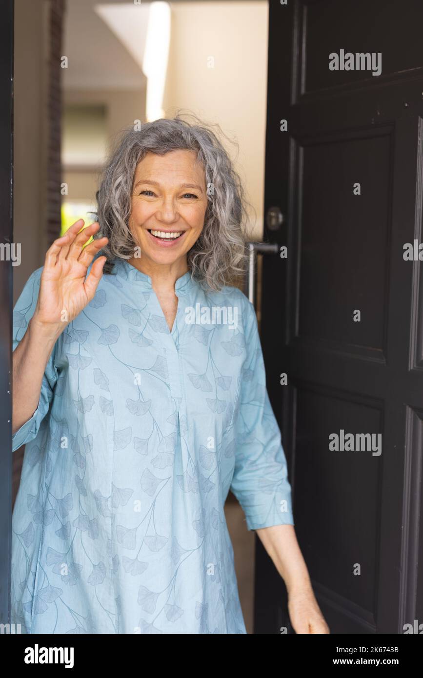 Vertical Picture Of Happy African Senior Caucasian Women Opening Door