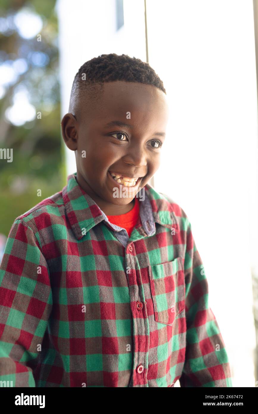 Vertical picture of happy african american boy welcoming somebody ...