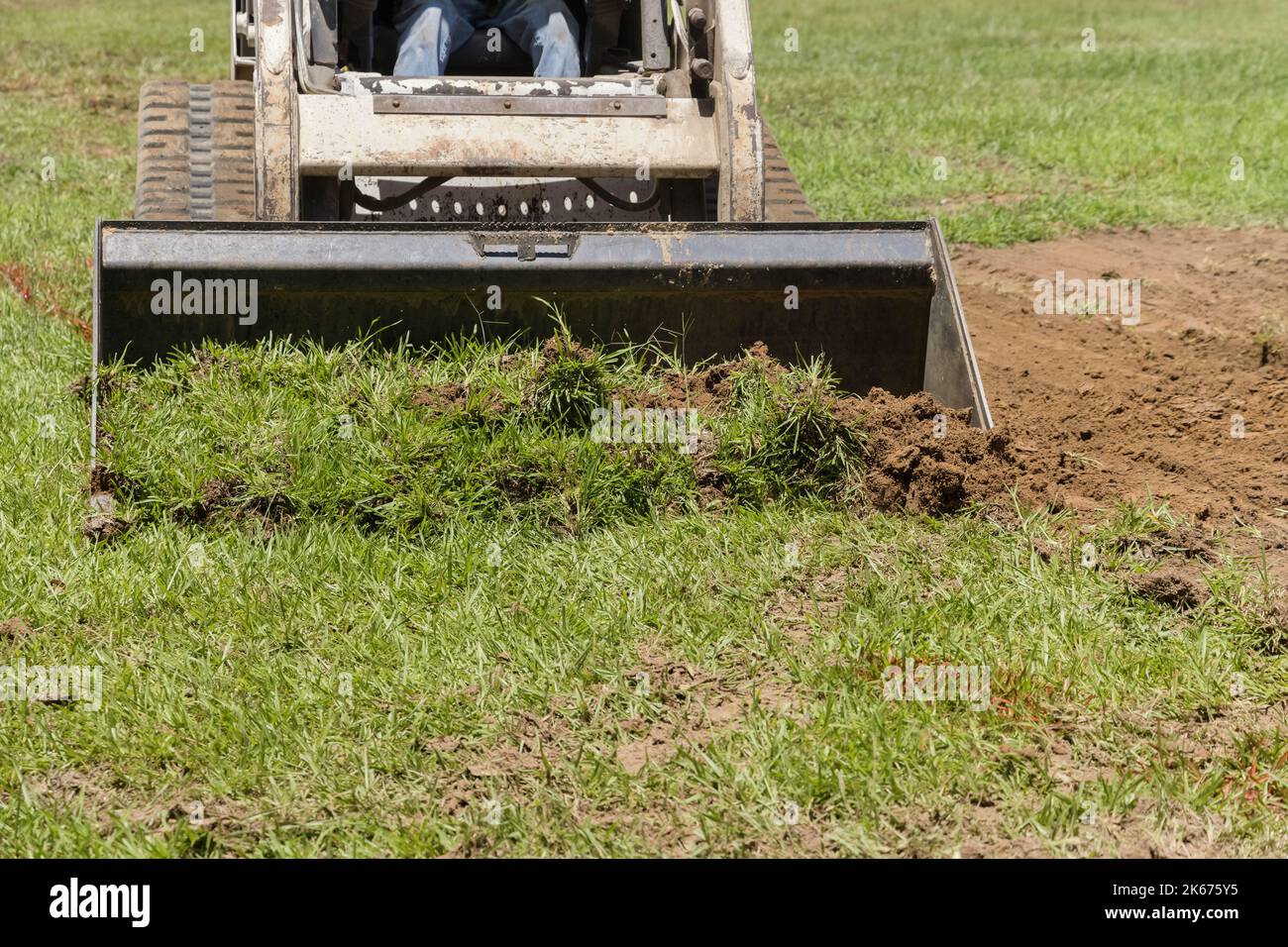 Bulldozer is being used to move earth with the scoop as for landscaping ...