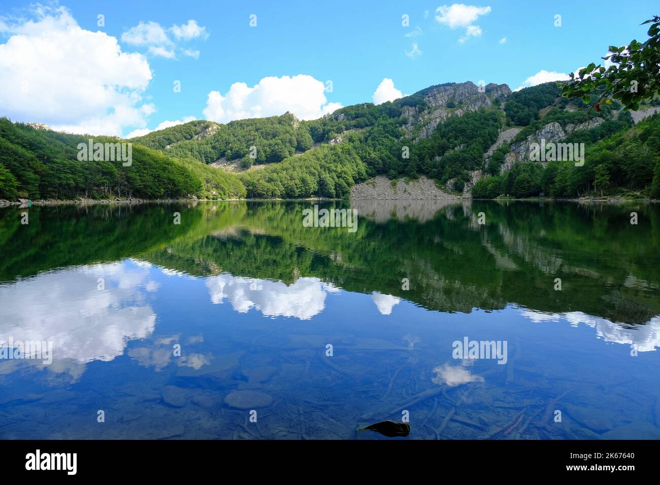 Lake Santo, Lago Santo across the mountains and woods. Nature reflects ...